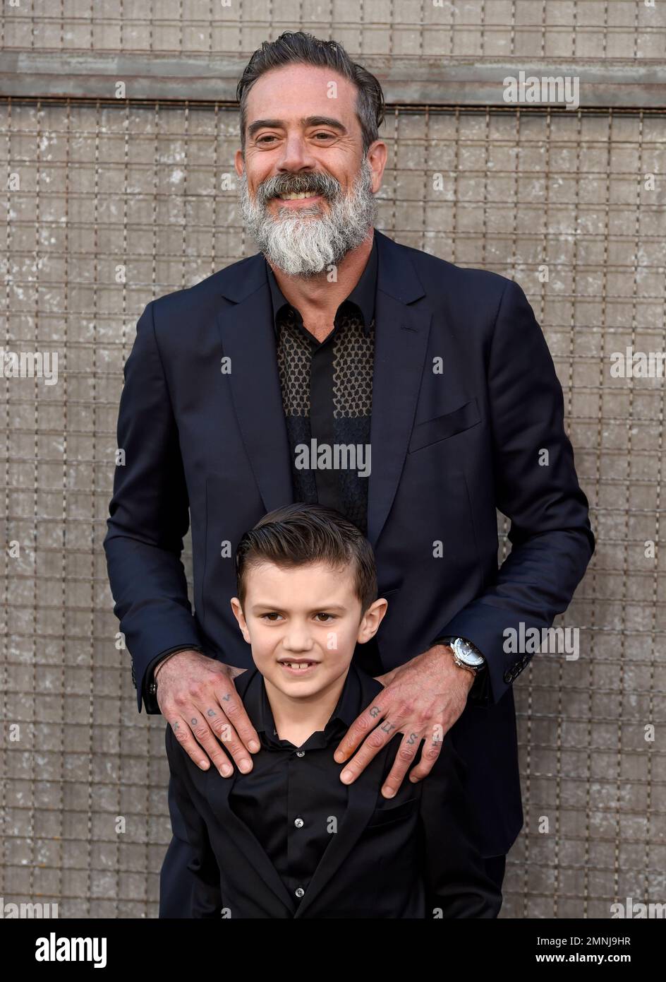 Jeffrey Dean Morgan, in background, and his son Augustus Morgan arrive ...