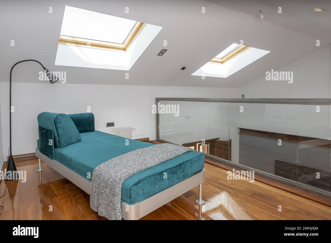 Living room of a loft-style house with sloping ceilings and skylights ...
