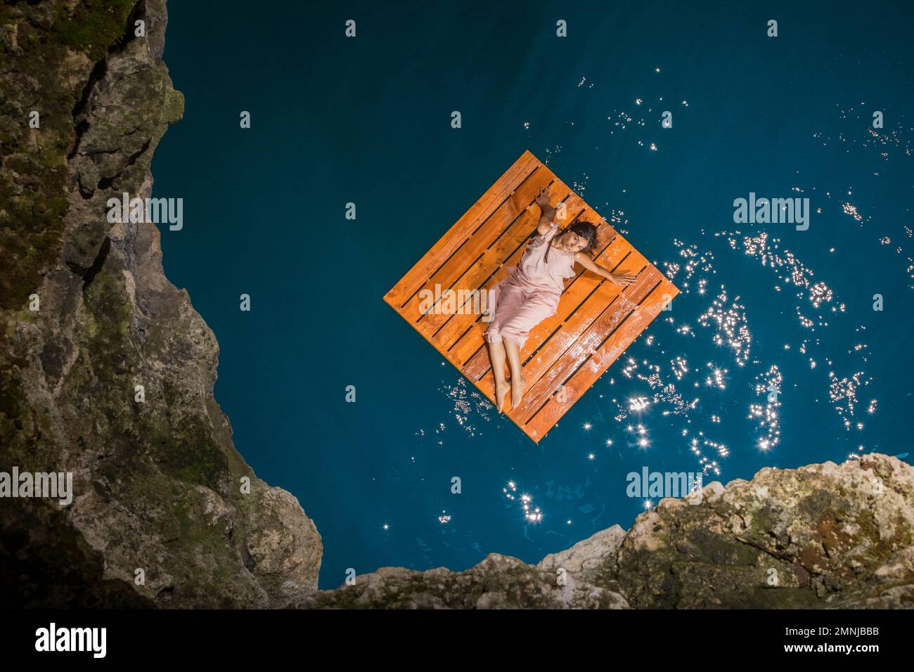 Aerial view of woman lying on wooden raft Stock Photo - Alamy