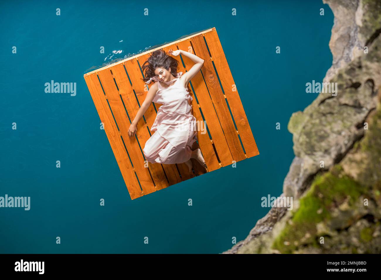 Aerial view of woman lying on wooden raft Stock Photo - Alamy