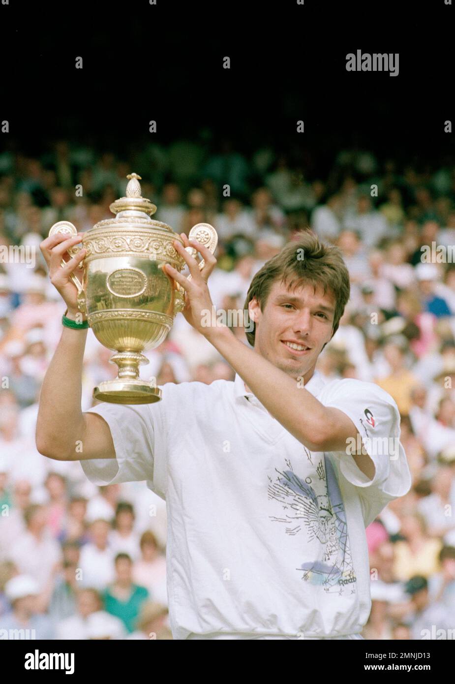 Wimbledon champion Michael Stich holds his trophy aloft after beating ...