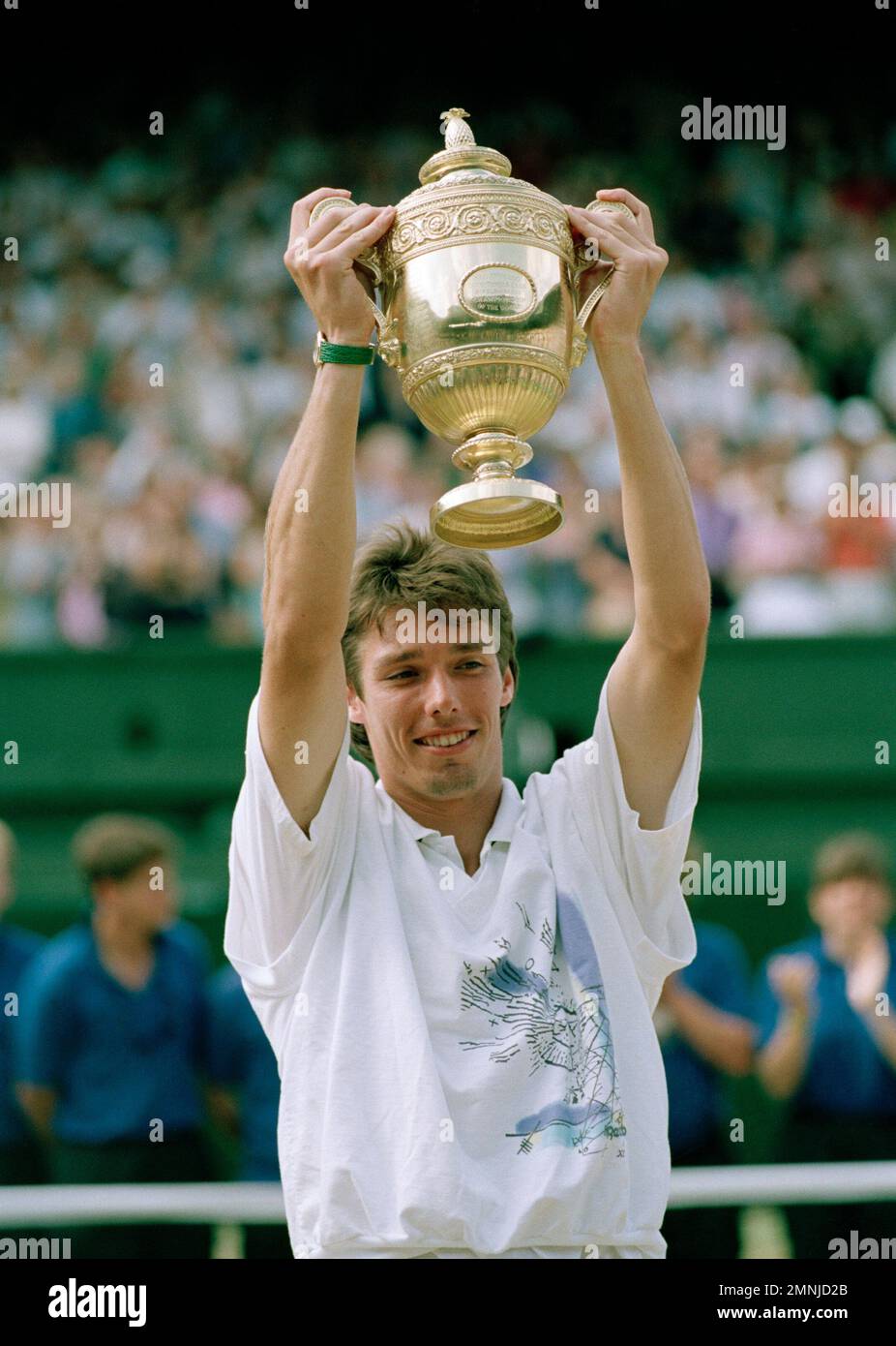 Wimbledon champion Michael Stich holds his trophy aloft after beating ...