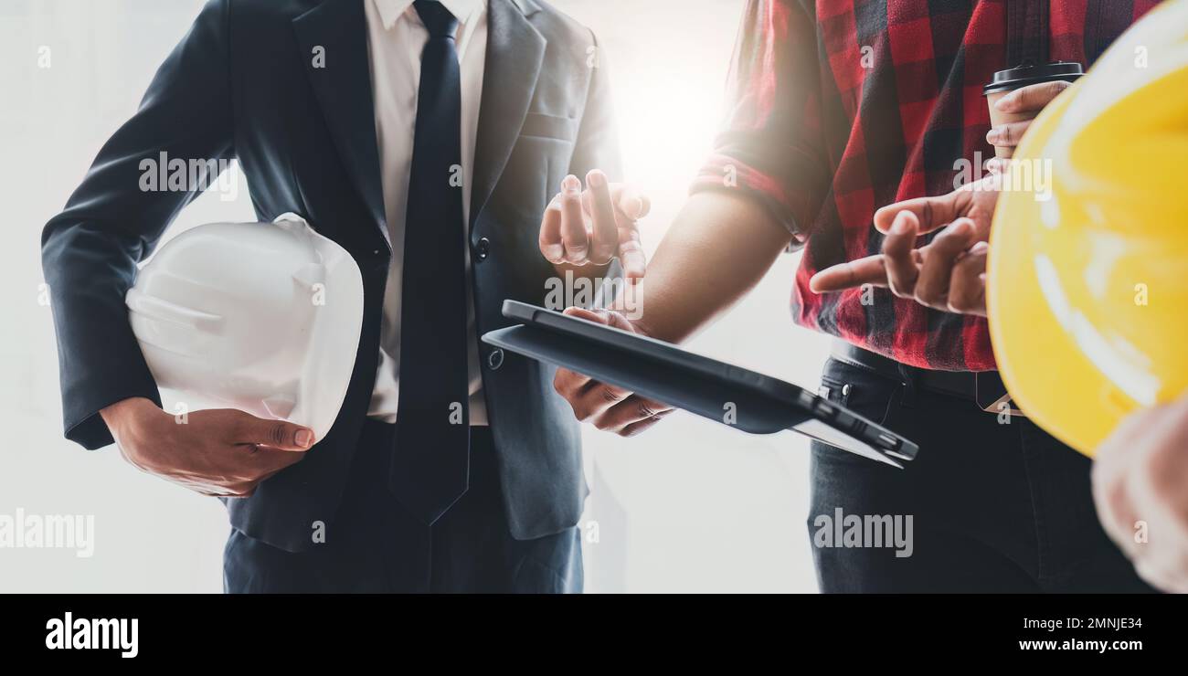 Architect Team Working With Blueprints On Tablet For Architectural Plan Engineer Sketching A