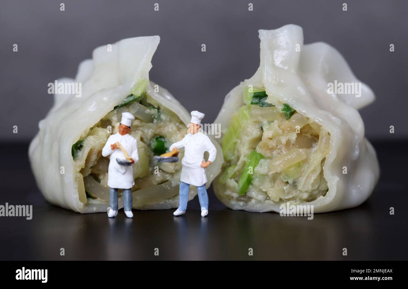 Steamed dumplings and two miniature chefs. Miniature people and steamed ...
