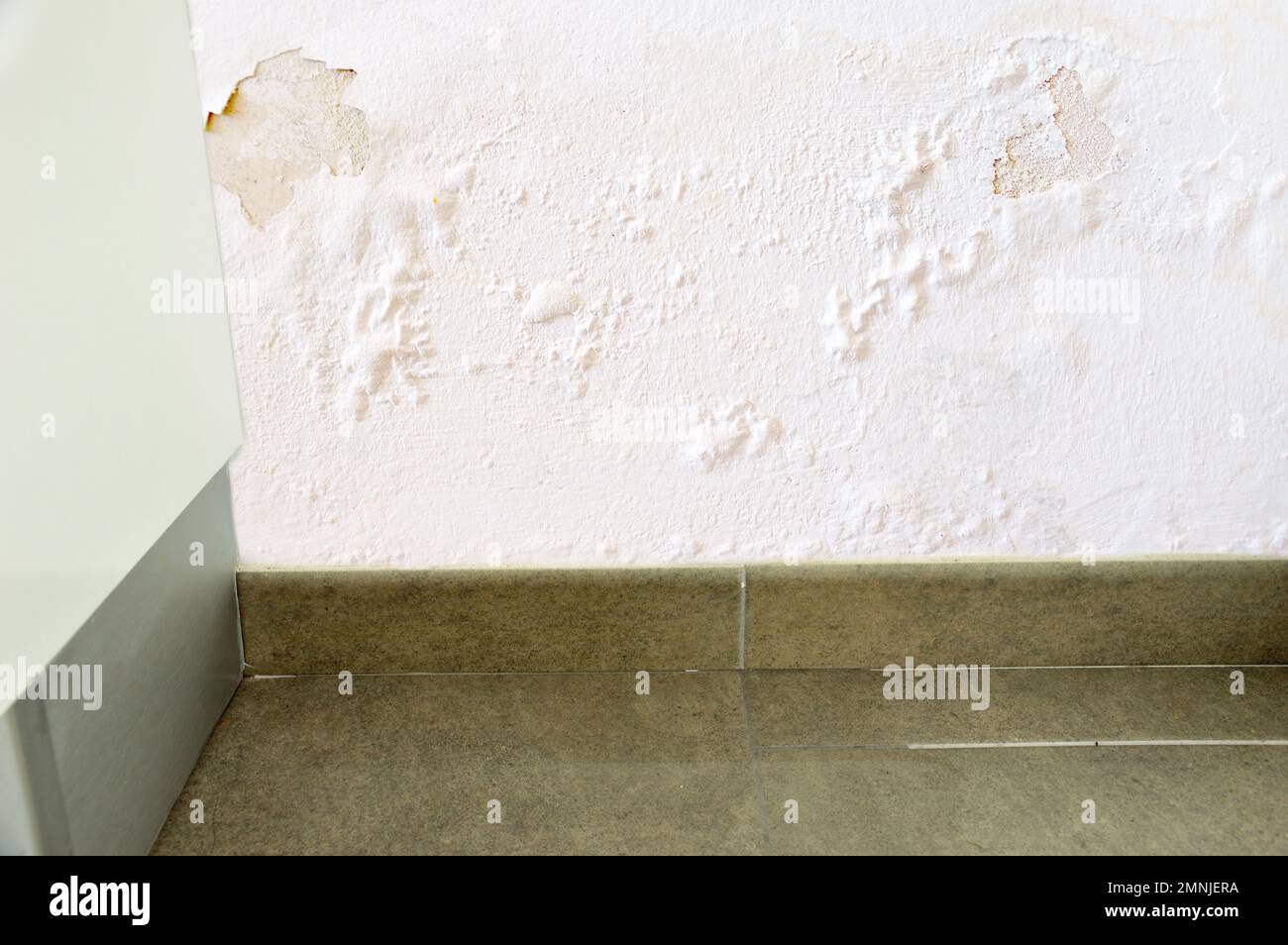 Damage caused by damp on a wall in modern kitchen Stock Photo - Alamy