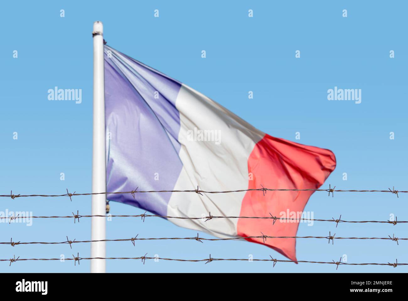 Metal fence with barbed wire on a French flag. Separation concept ...