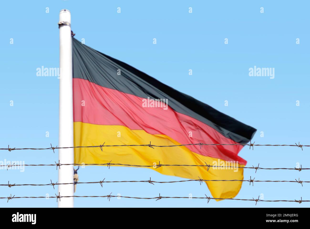 Metal fence with barbed wire on a Germany flag. Separation concept ...