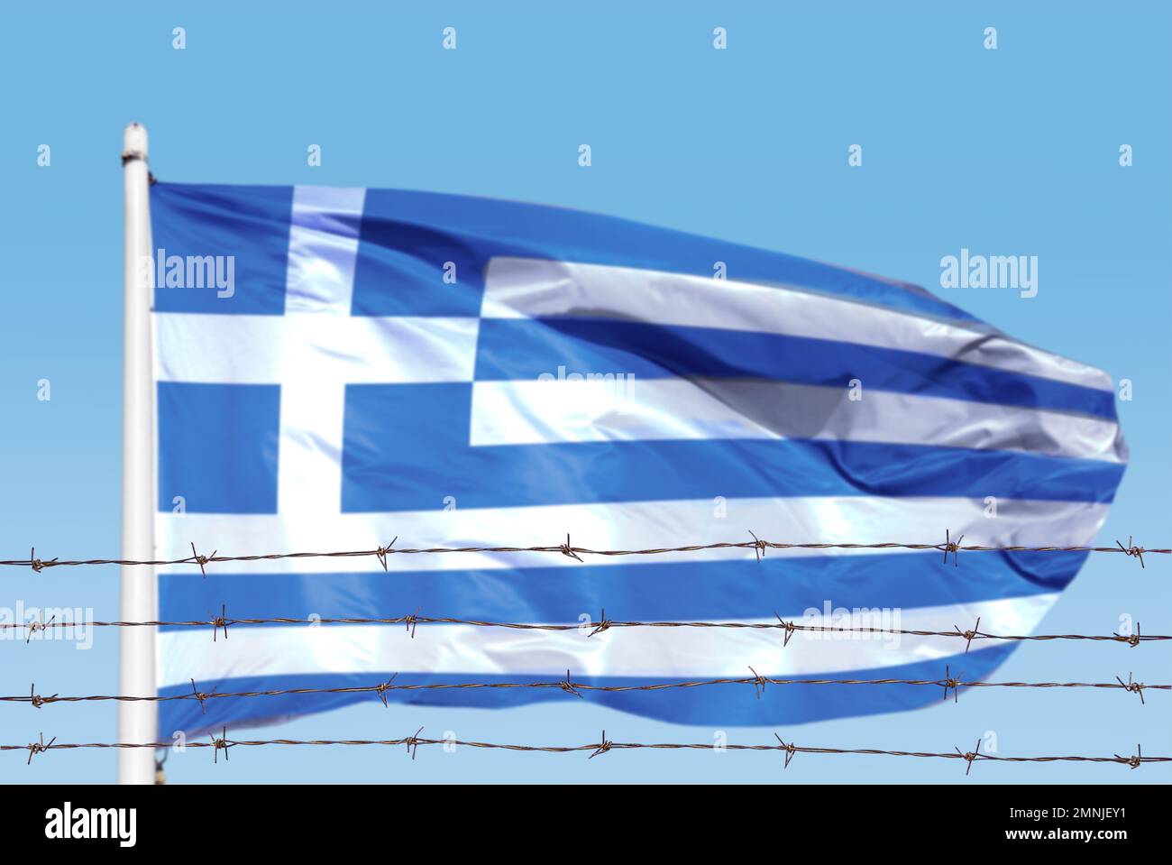 Metal fence with barbed wire on a Greek flag. Separation concept ...