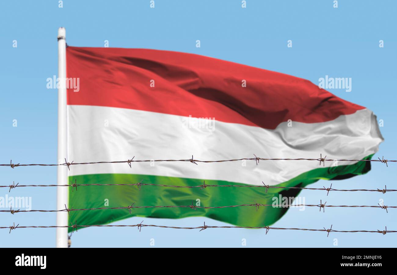 Metal fence with barbed wire on a Hungarian flag. Separation concept ...