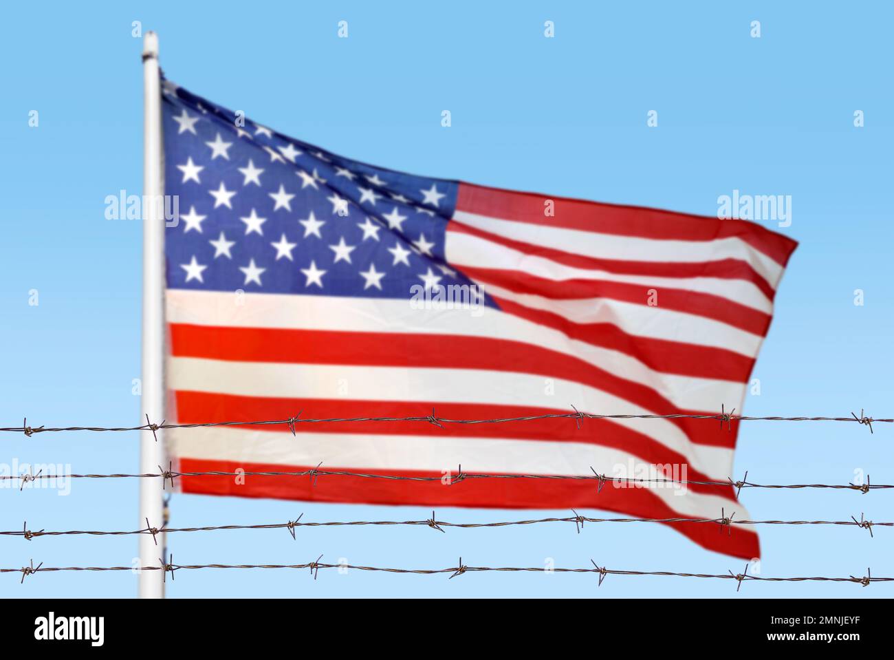 Metal fence with barbed wire on a USA flag. Separation concept, borders ...