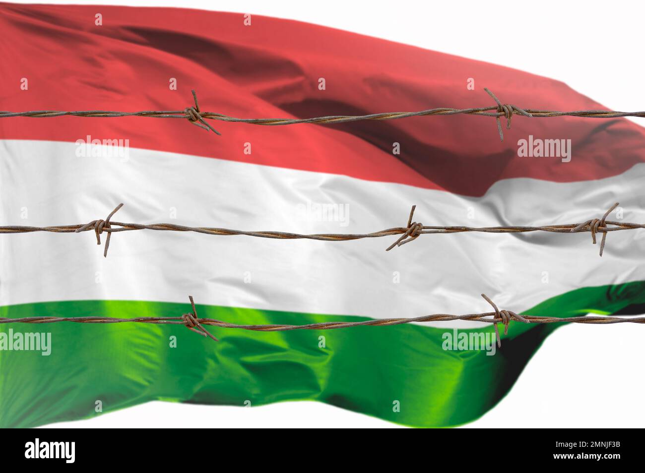 Metal fence with barbed wire on a Hungarian flag. Separation concept ...