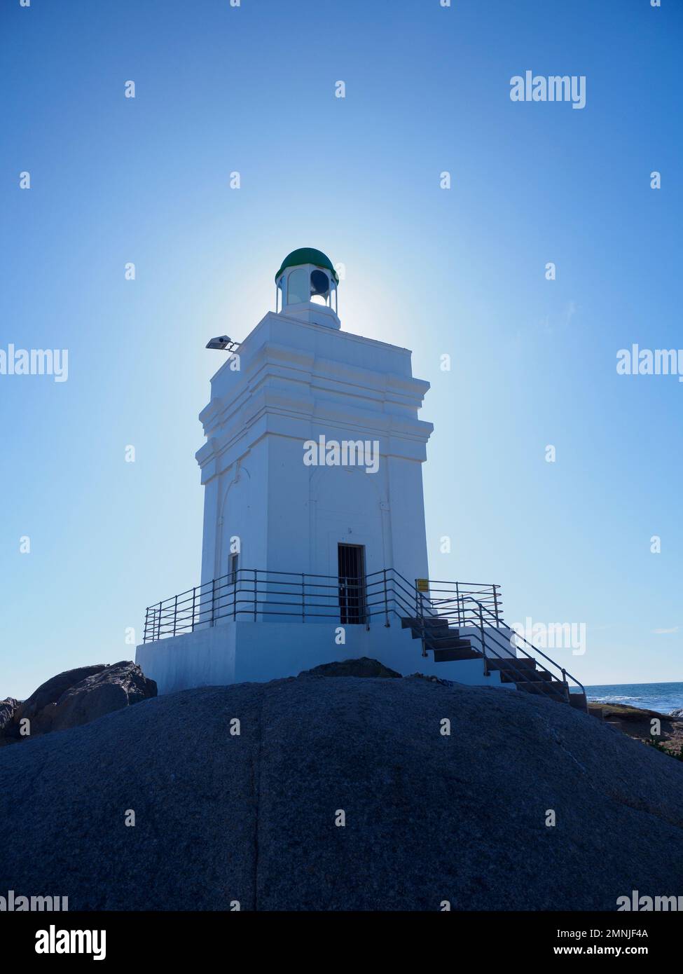 South Africa, Western Cape, St Helena, White lighthouse on sea coast ...