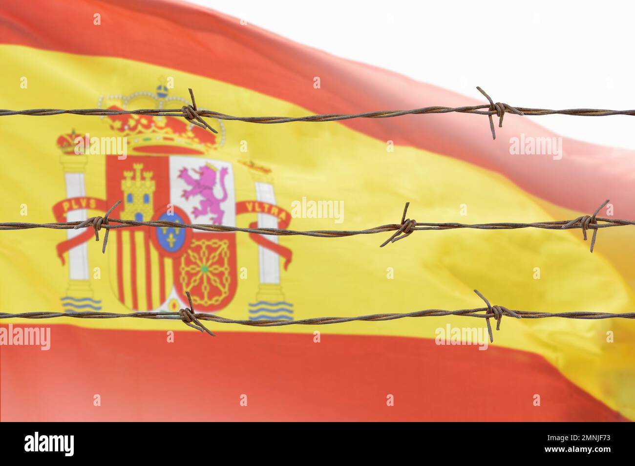 Metal fence with barbed wire on a Spanish flag. Separation concept ...