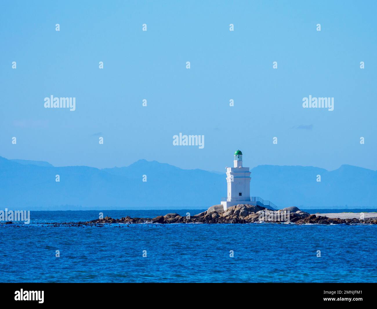 South Africa, Western Cape, St Helena, White lighthouse on sea coast ...
