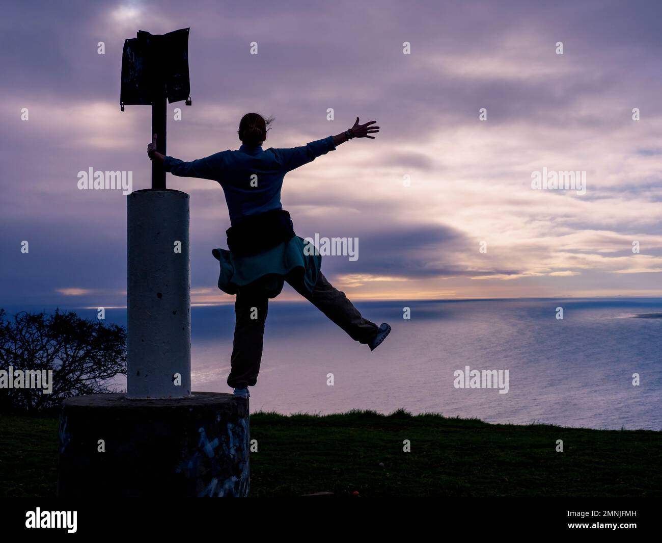Woman standing on ocean coast hi-res stock photography and images - Alamy