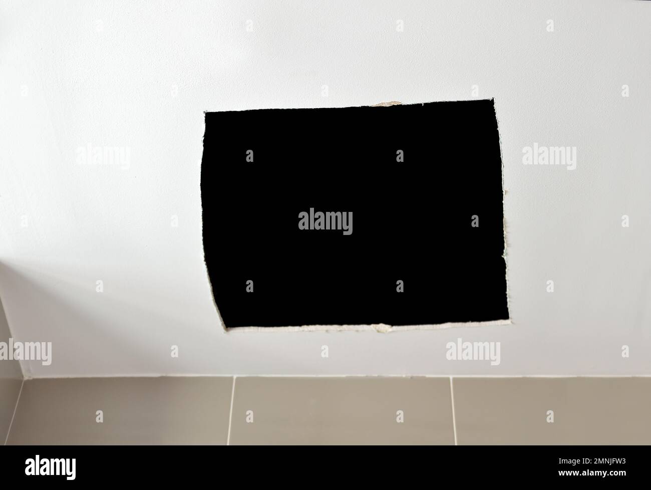 Ceiling panels damaged as a huge hole in the roof from rainwater ...