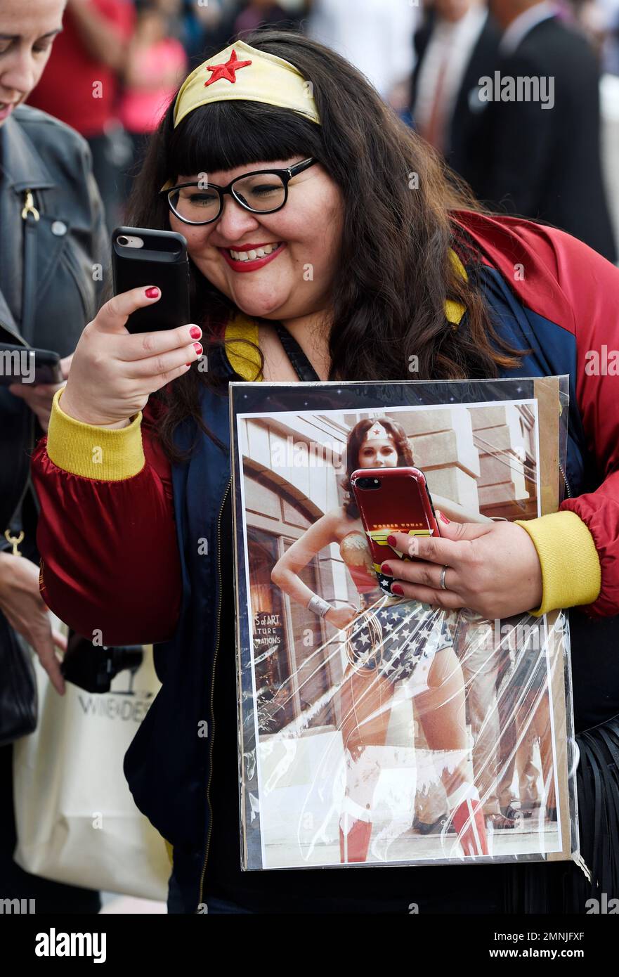 Elizabeth Paravicini holds a photo of actress Lynda Carter in character ...