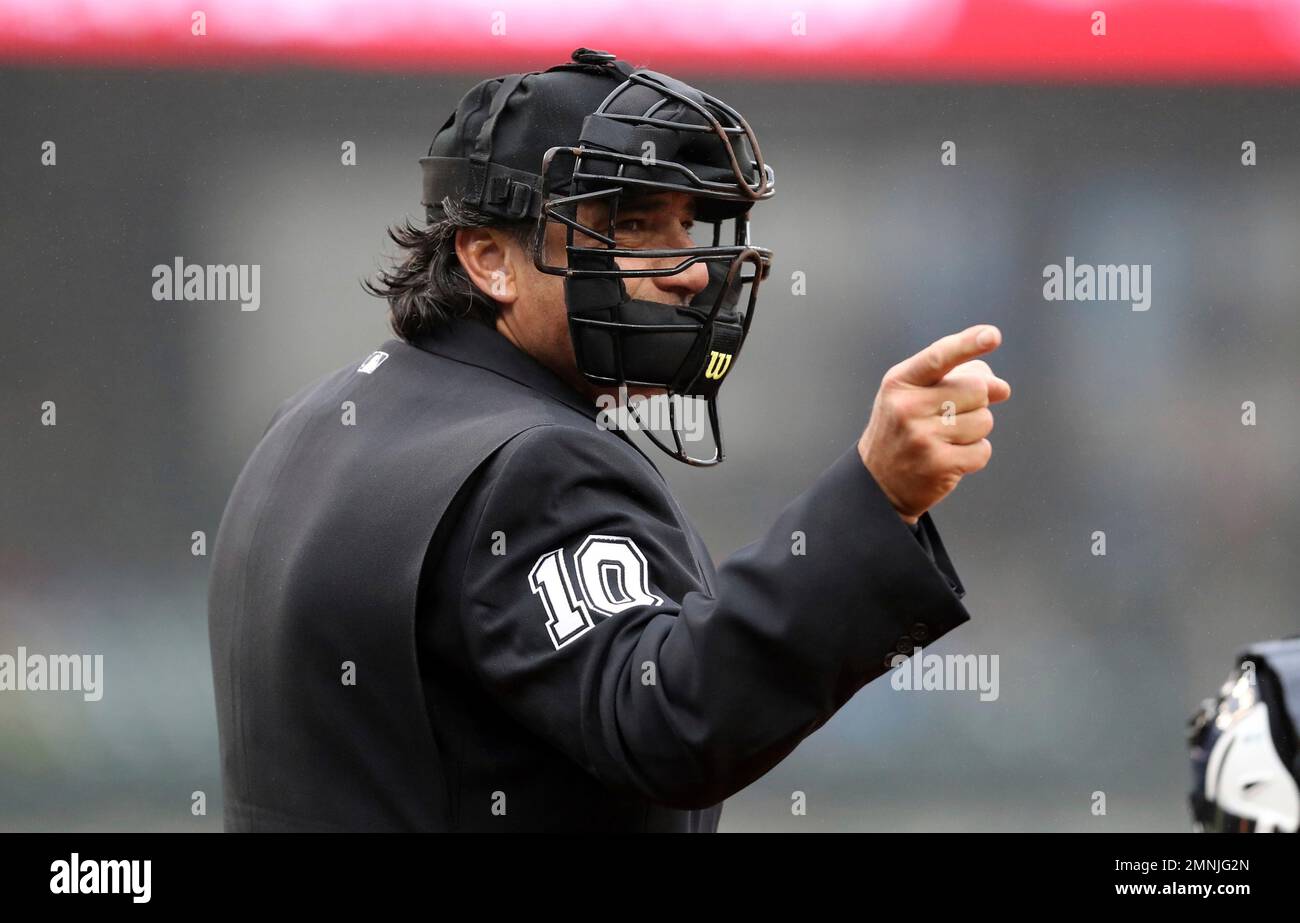 Umpire Phil Cuzzi signals during the sixth inning of a baseball game ...