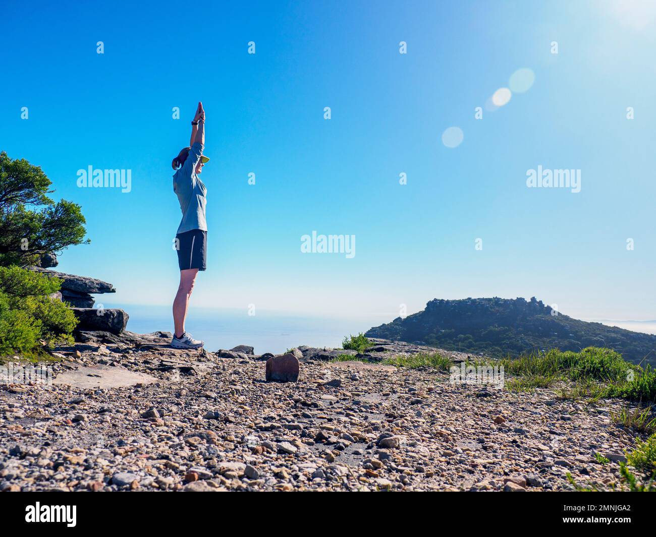 South Africa, Western Cape, Cape Town, Woman standing on cliff with ...