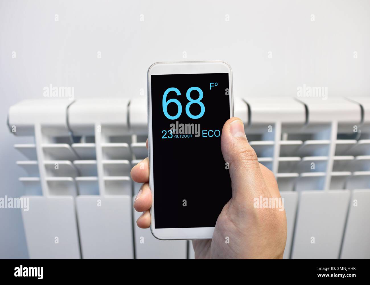 close up of a person hand adjusting temperature on thermostat through ...