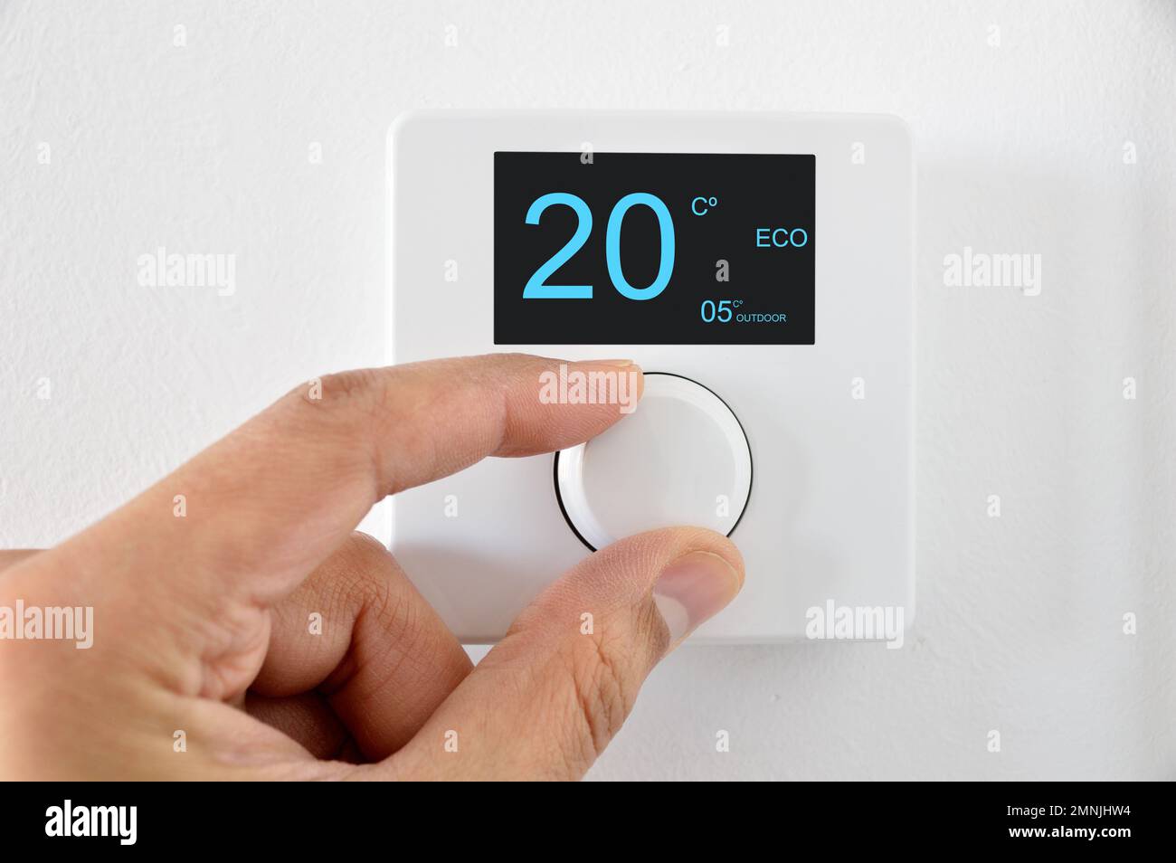 One hand adjust thermostat digital in celsius at home Stock Photo - Alamy