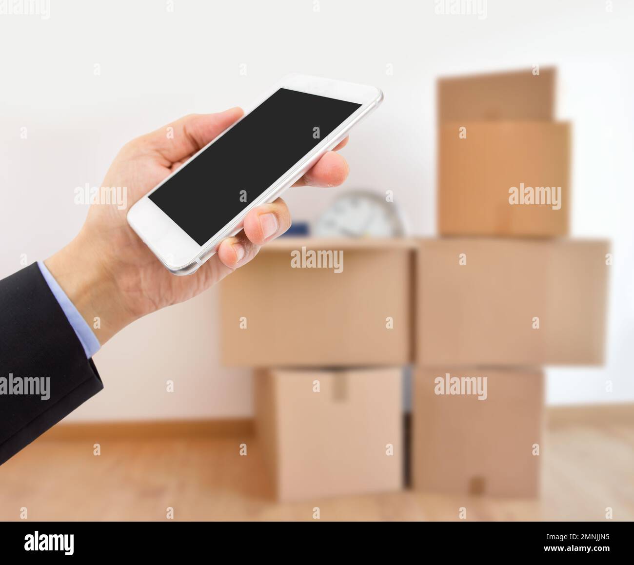 Unrecognizable business person moving office and using an app on a cell ...