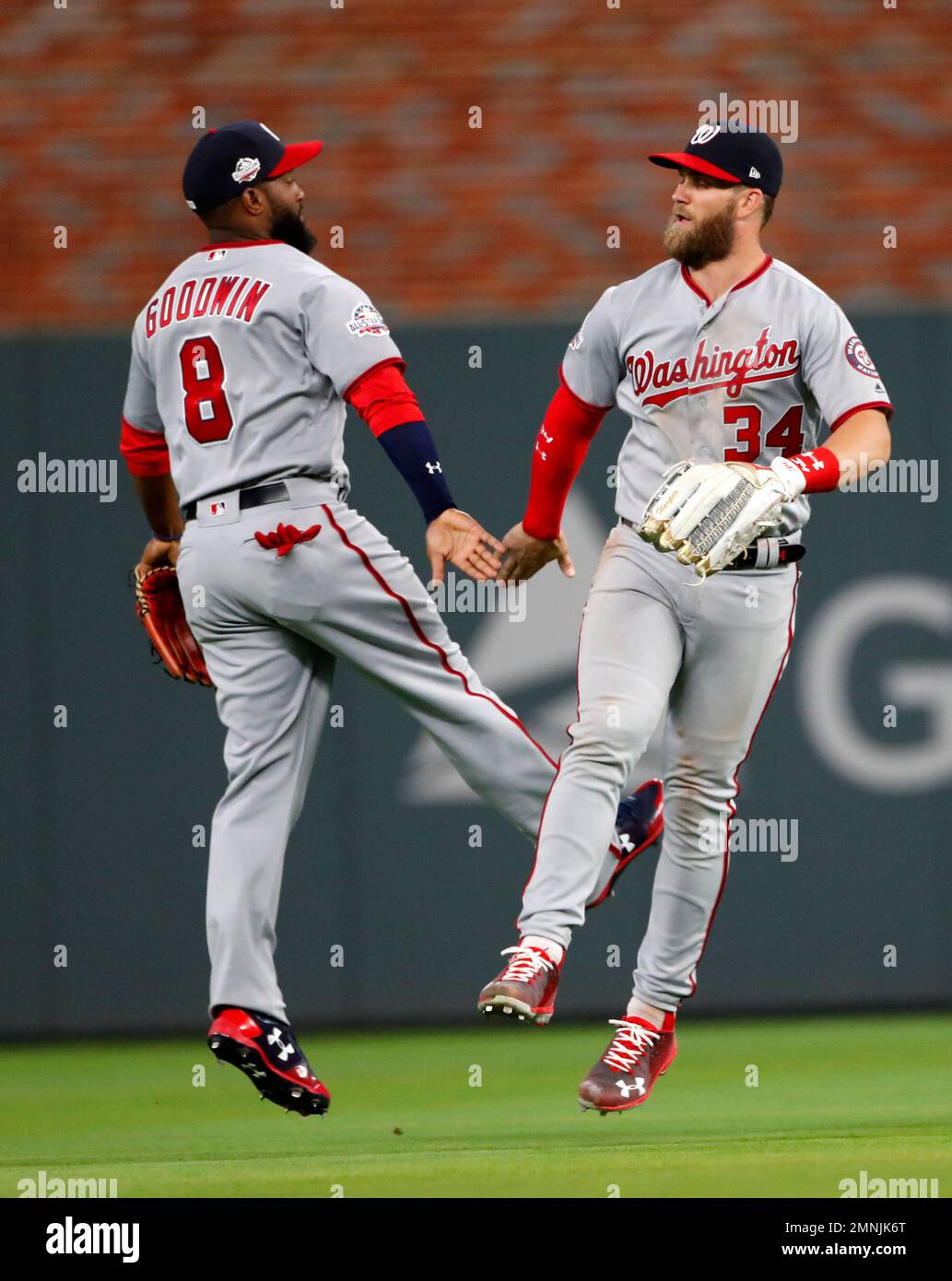 Washington Nationals' Bryce Harper (34) and Brian Goodwin (8) celebrate ...