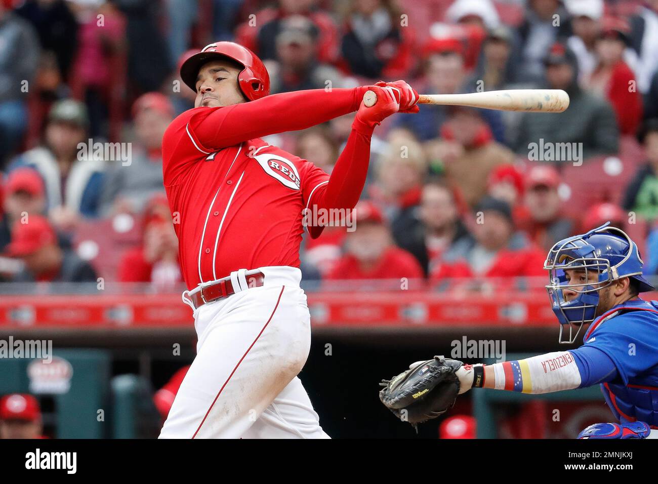 Cincinnati Reds' Eugenio Suarez hits a single off Chicago Cubs relief pitcher Pedro Strop in the ...