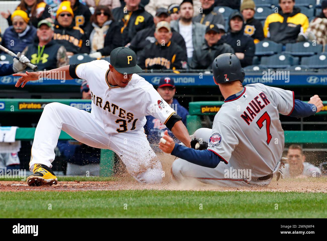 Minnesota Twins' Joe Mauer (7) scores on wild pitch ahead of the tag by ...