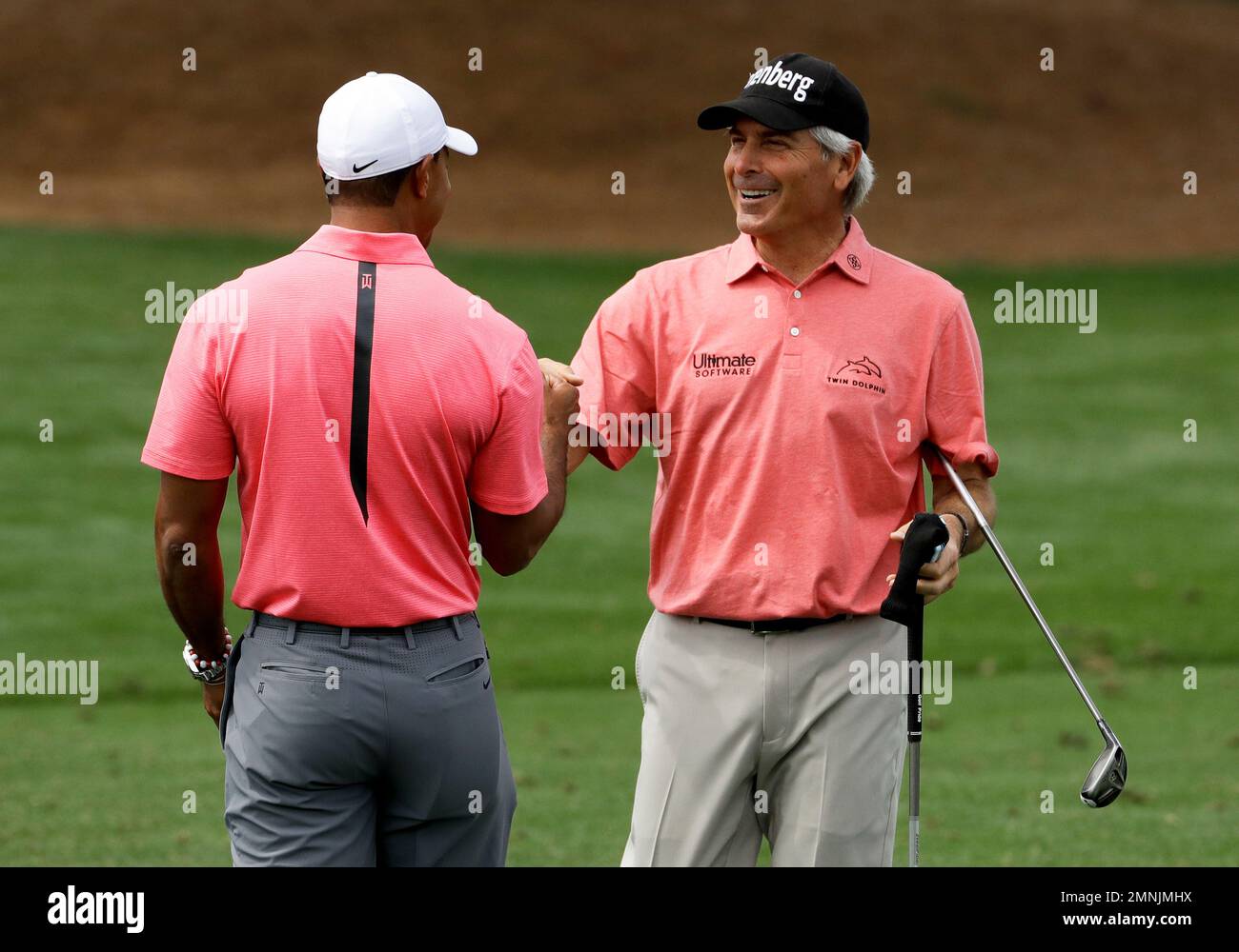 Tiger Woods, left, greets Fred Couples on the driving range during ...