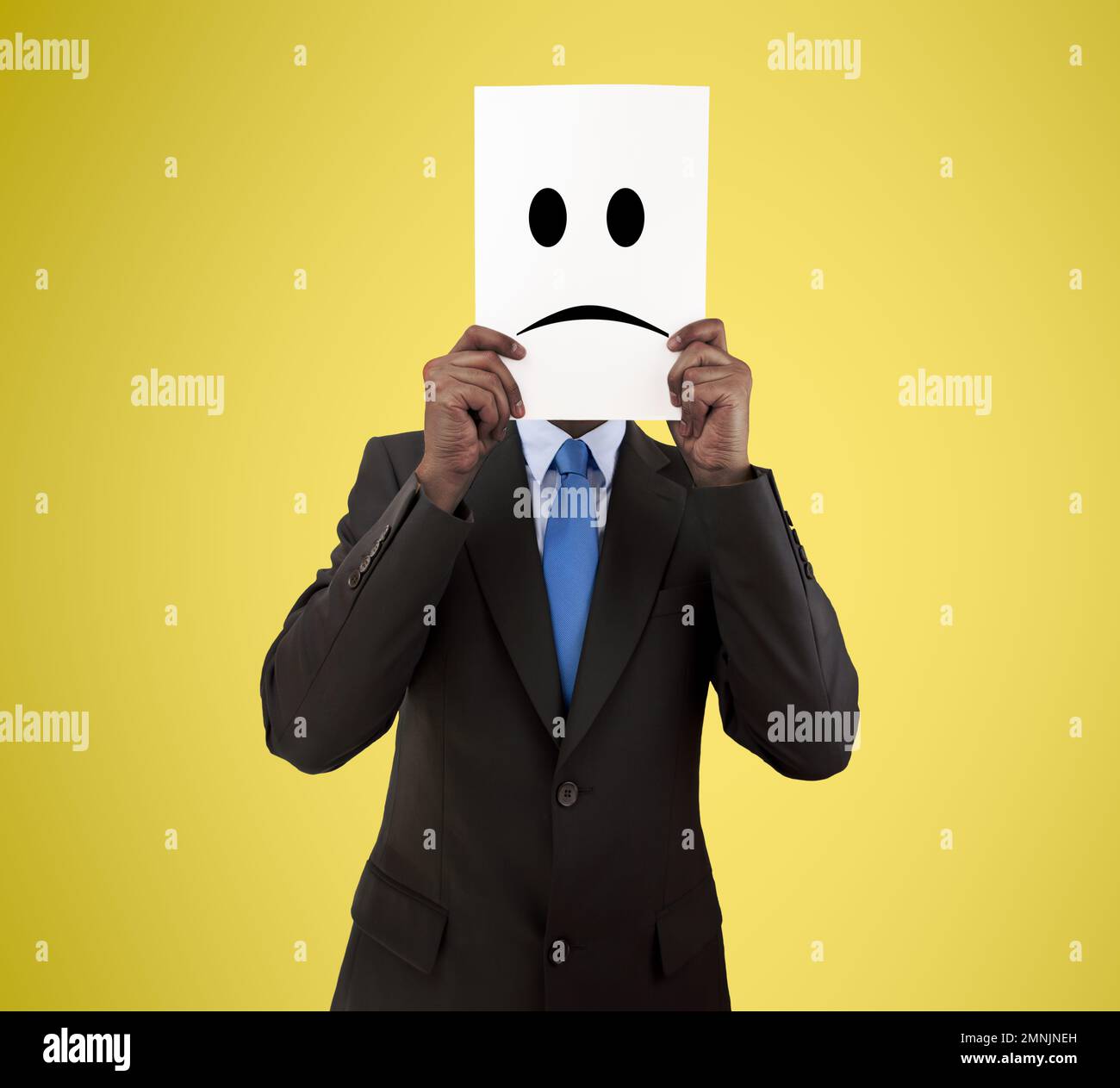 businessman showing a negative emoticon in front of his face on a ...