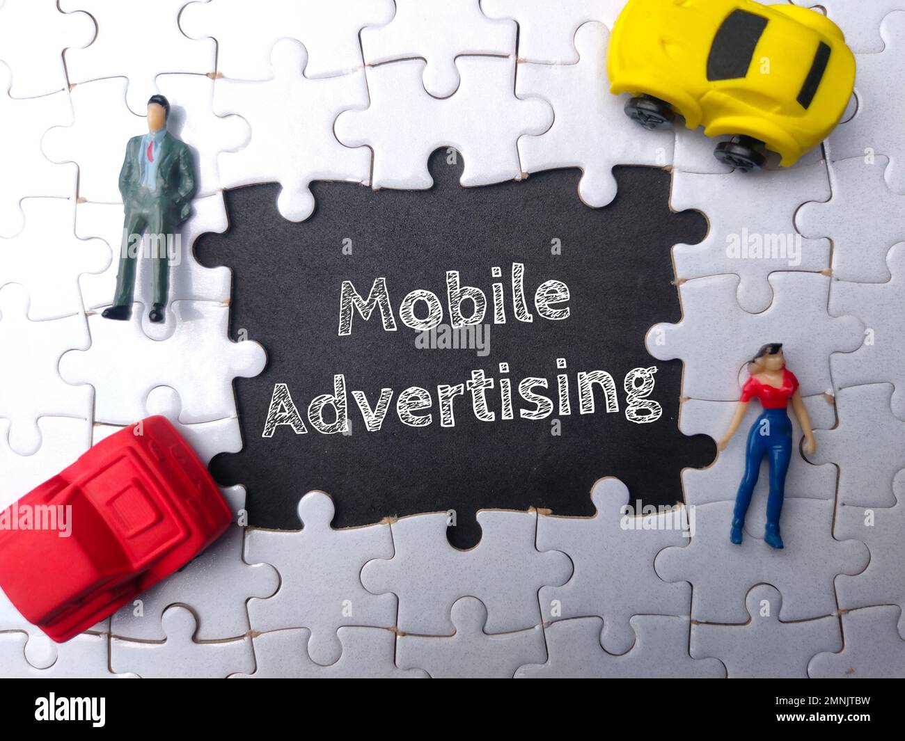 Toys car and miniature people with the word Moblie Advertising Stock ...