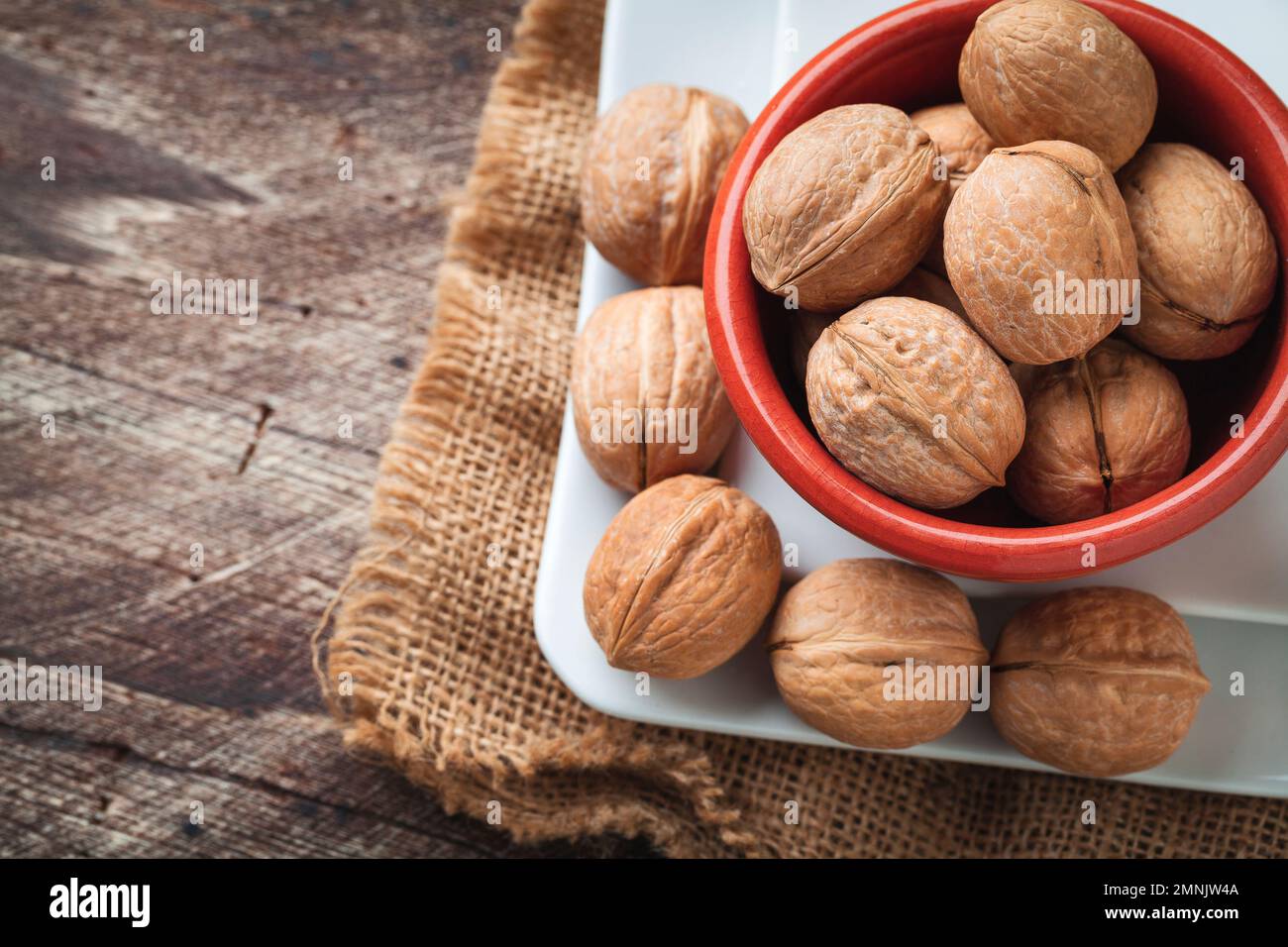 handful of nuts on a sheet of jute a bowl Stock Photo - Alamy