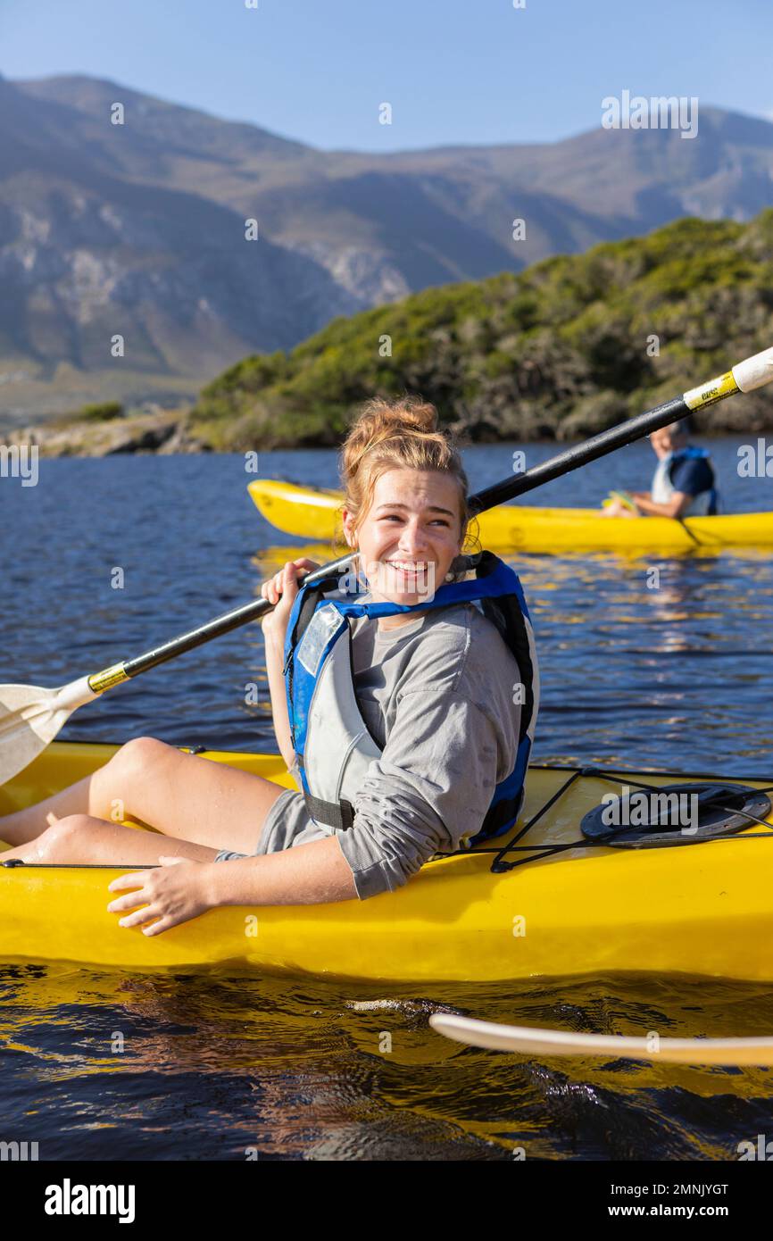 South Africa, Stanford, Smiling teenage girl (16-17) kayaking in lagoon ... South Africa, Stanford, Smiling teenage girl (16-17) kayaking in lagoon ...