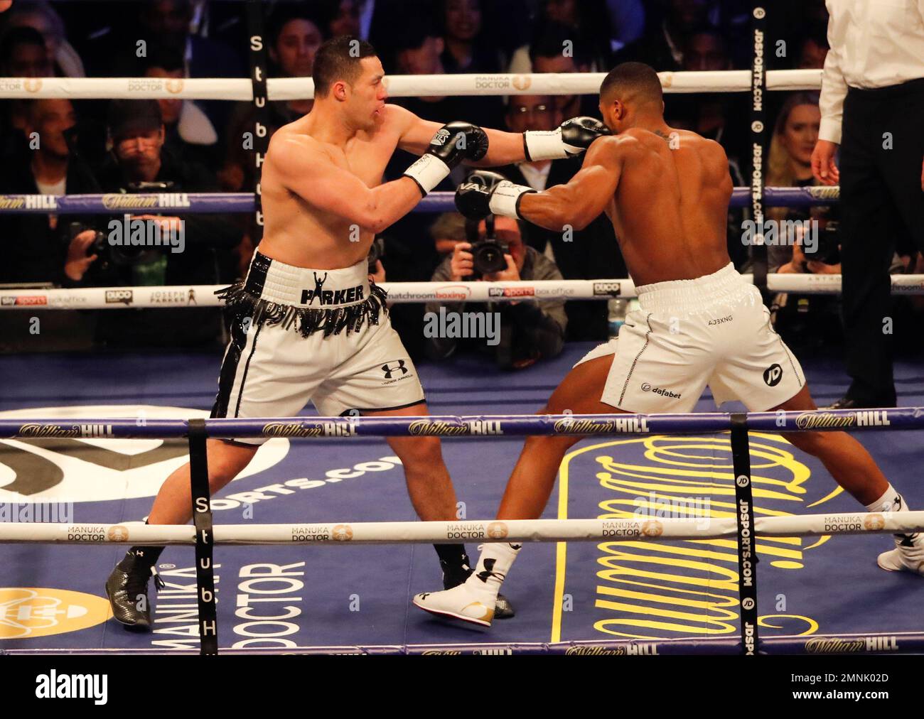 Britain's Anthony Joshua, right, takes a blow from New Zealand's Joseph Parker during their WBA ...