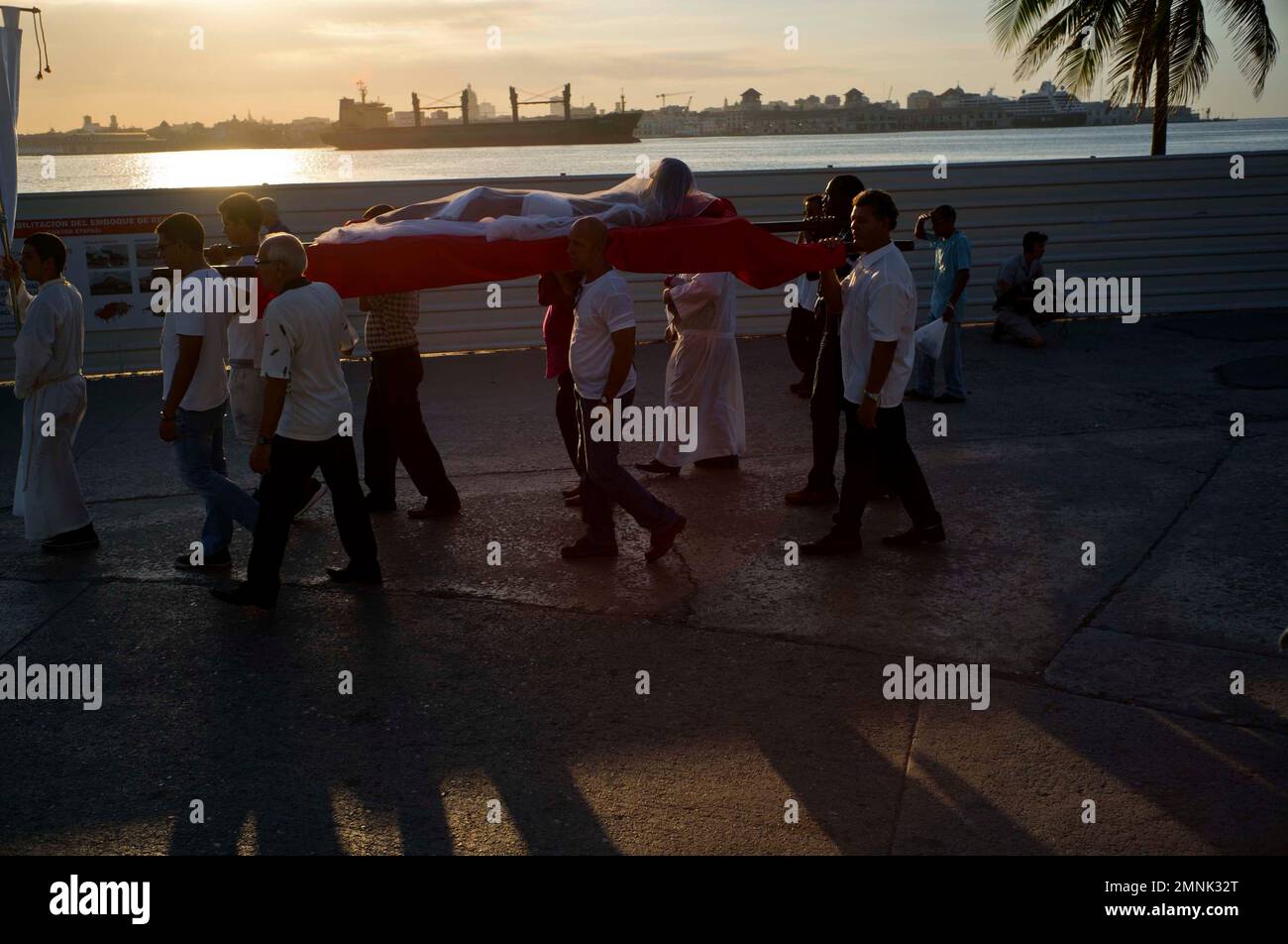 People carry a statue of Jesus Christ in a religious procession marking ...