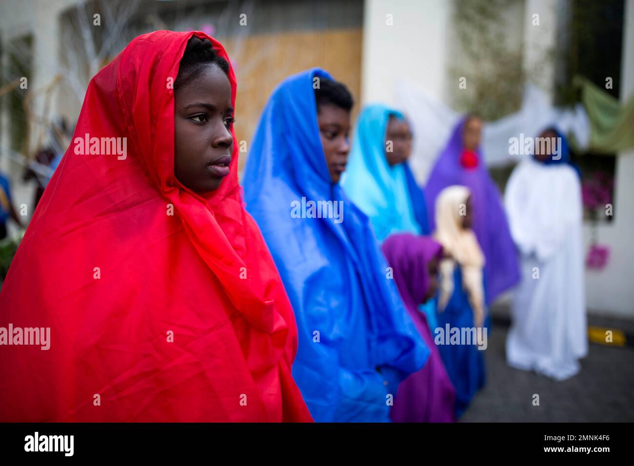 Women wait to take part in the Way of the Cross reenactment marking ...