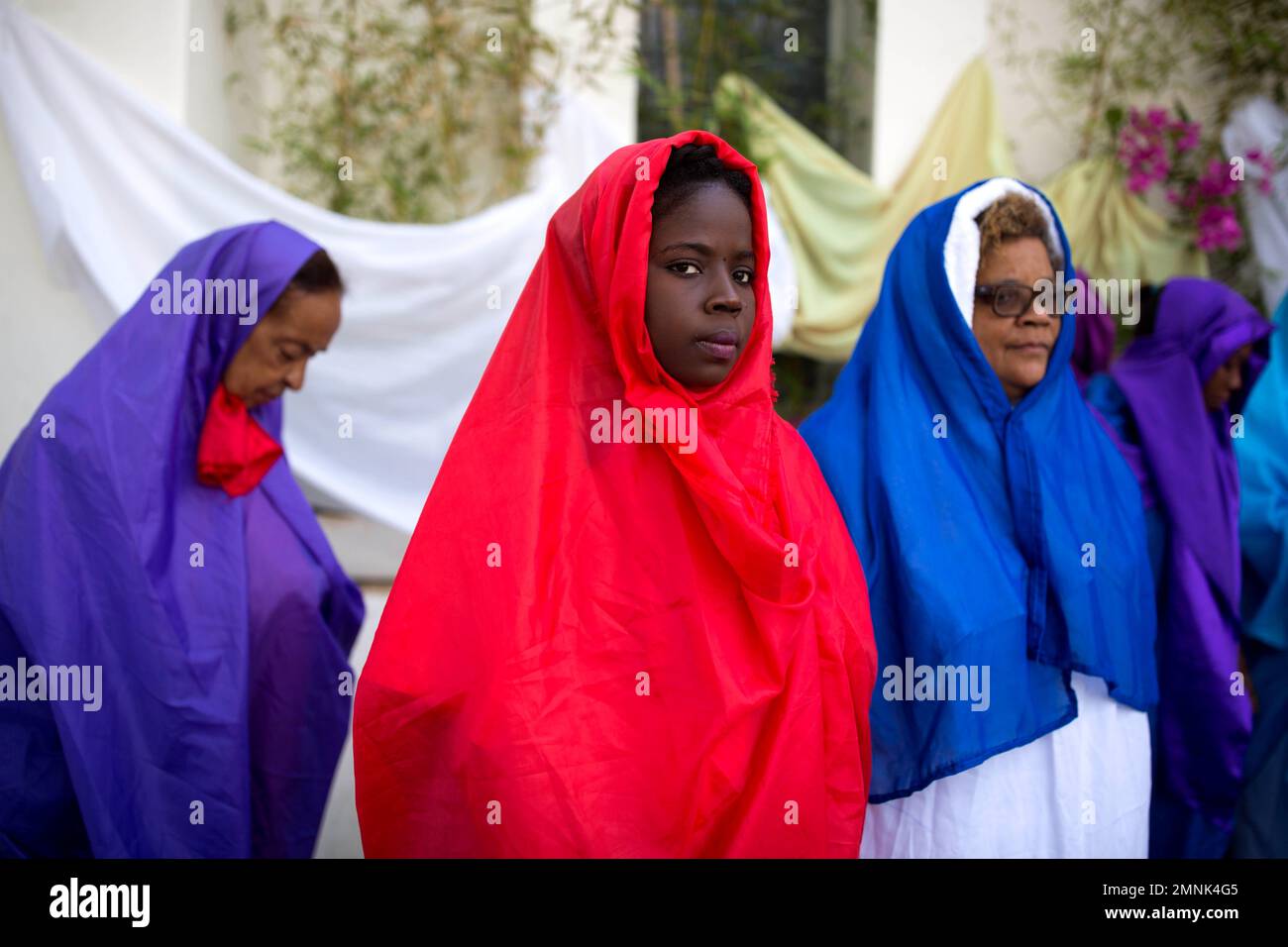 Women wait to take part in the Way of the Cross reenactment marking ...