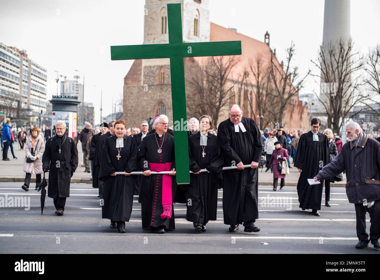 Priests carry a cross as they lead a procession to mark Good Friday in ...