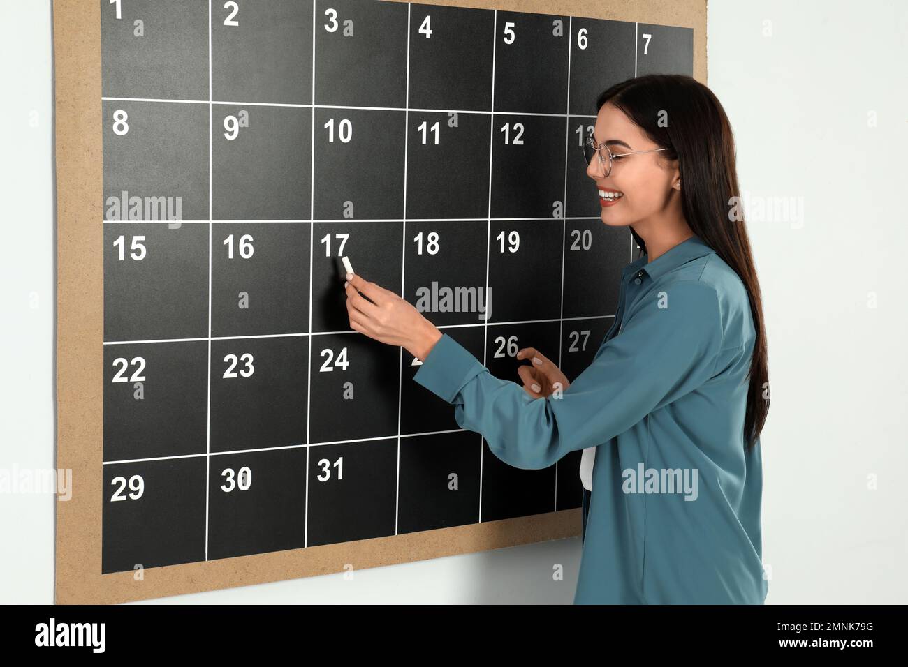 Woman writing on calendar hi-res stock photography and images - Alamy