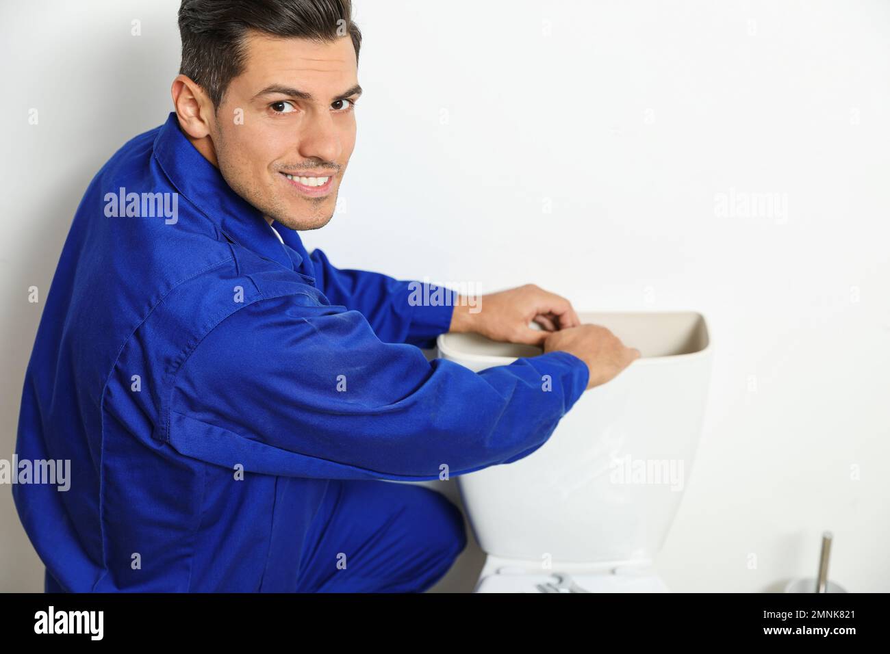 Professional plumber working toilet hi-res stock photography and images ...