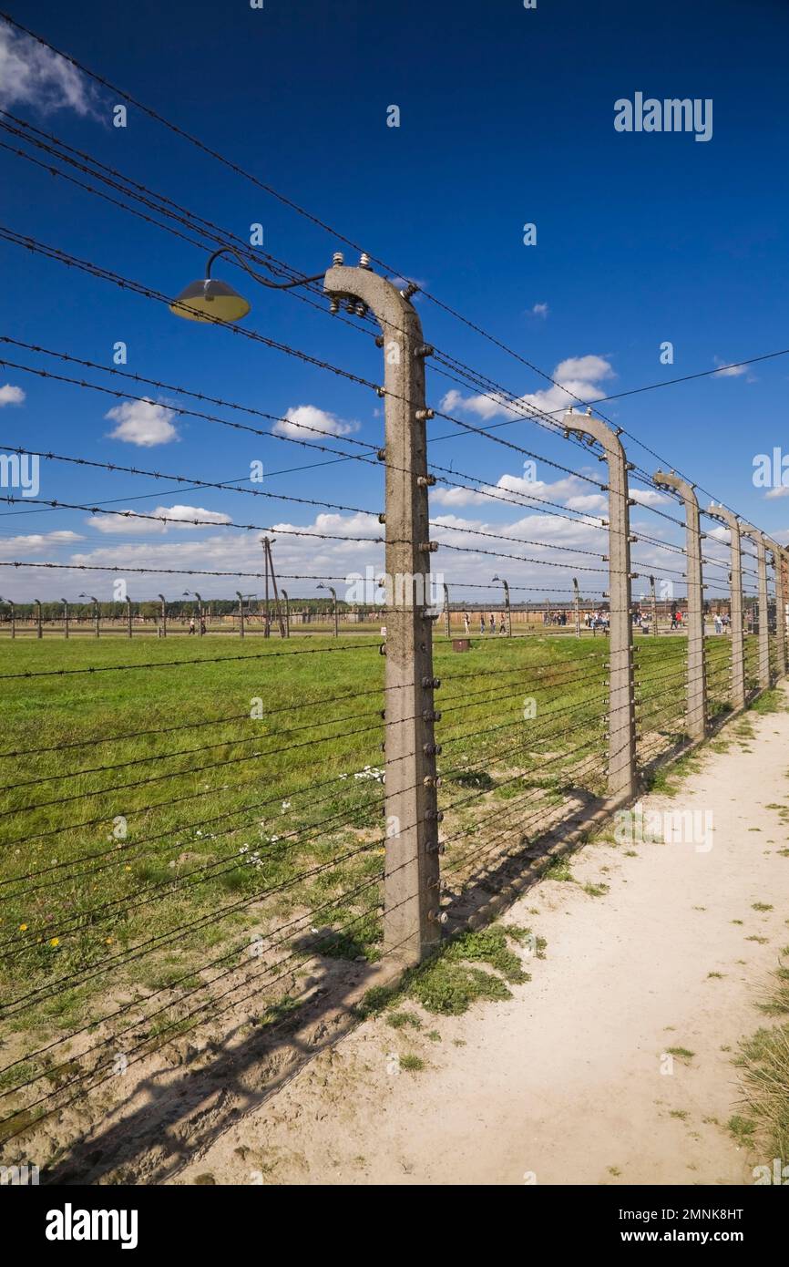Barb wire electric fence surrounding the Auschwitz II-Birkenau former ... Barb wire electric fence surrounding the Auschwitz II-Birkenau former ...