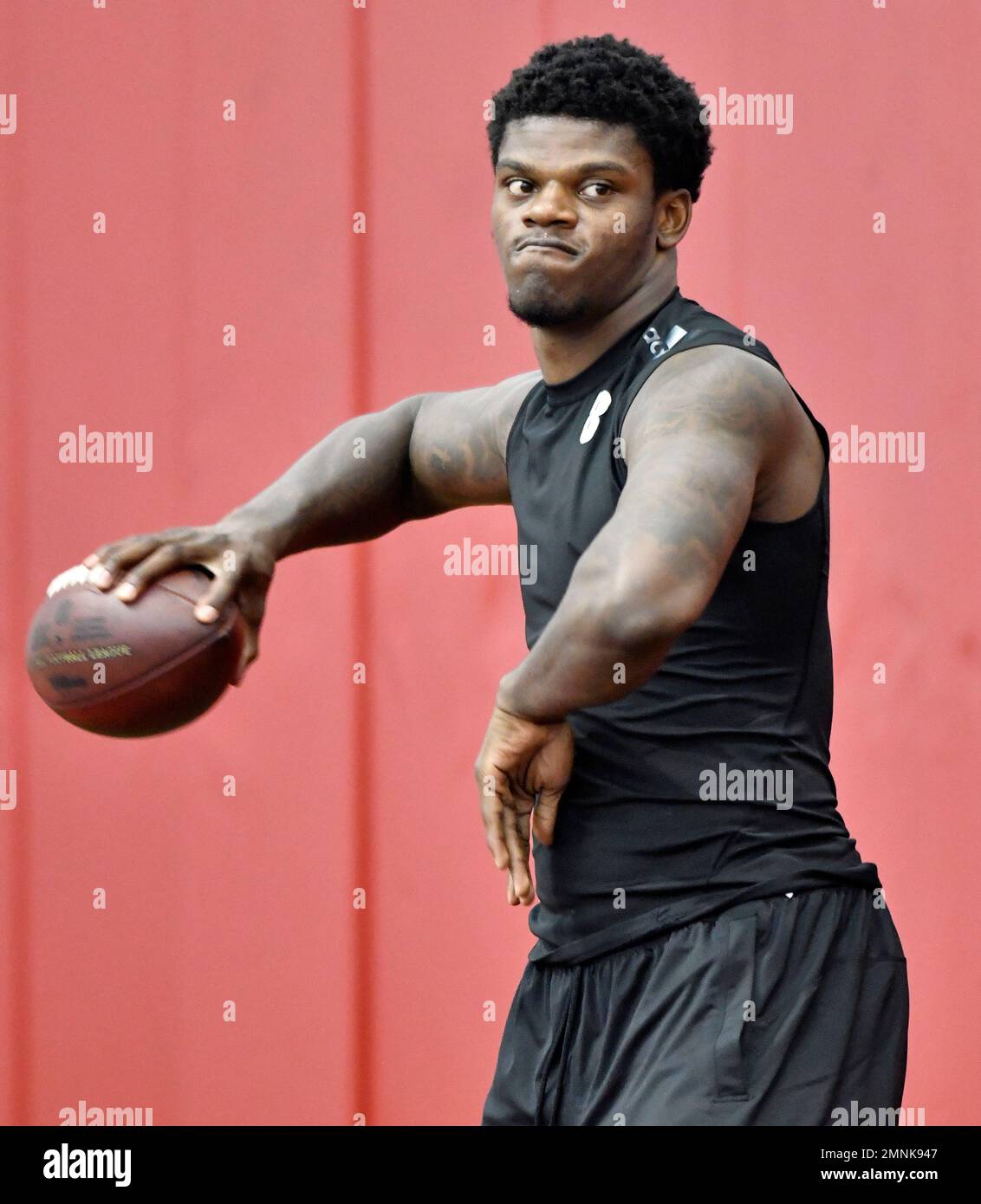 Lamar Jackson warms up before his workout in front of NFL scouts during ...