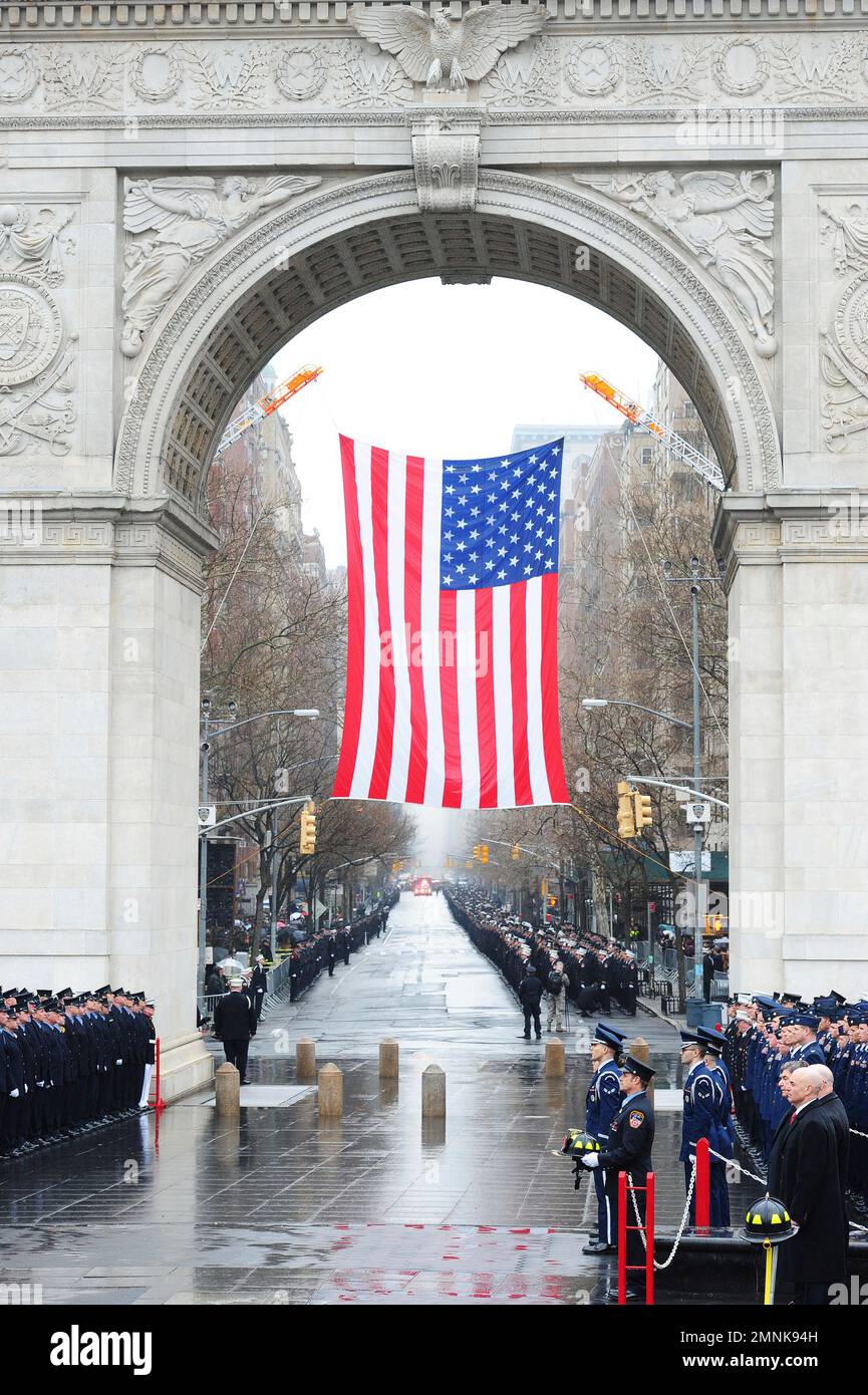 Firefighters stand at attention during a memorial service for ...