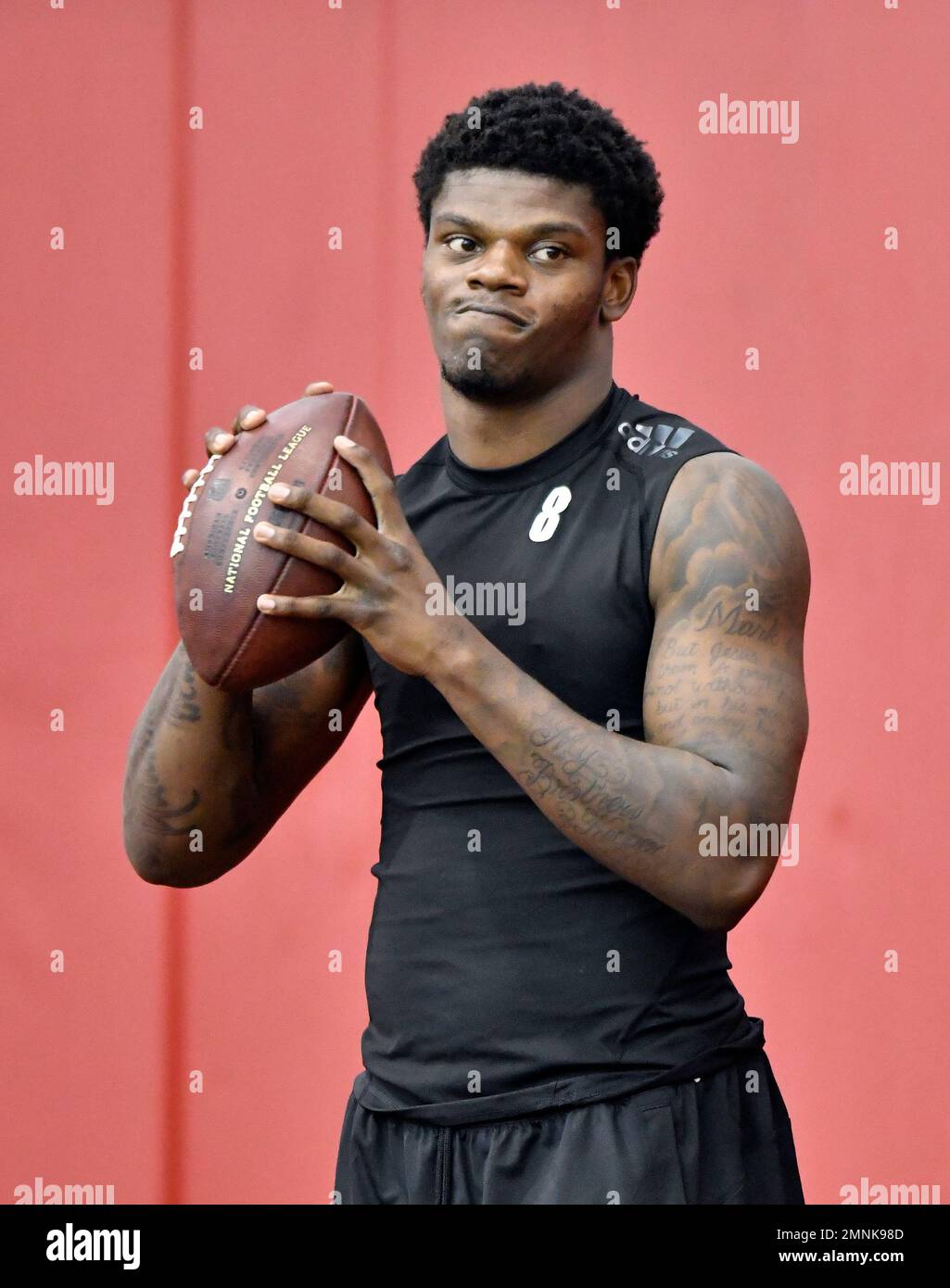 Lamar Jackson warms up before his workout in front of NFL scouts during ...