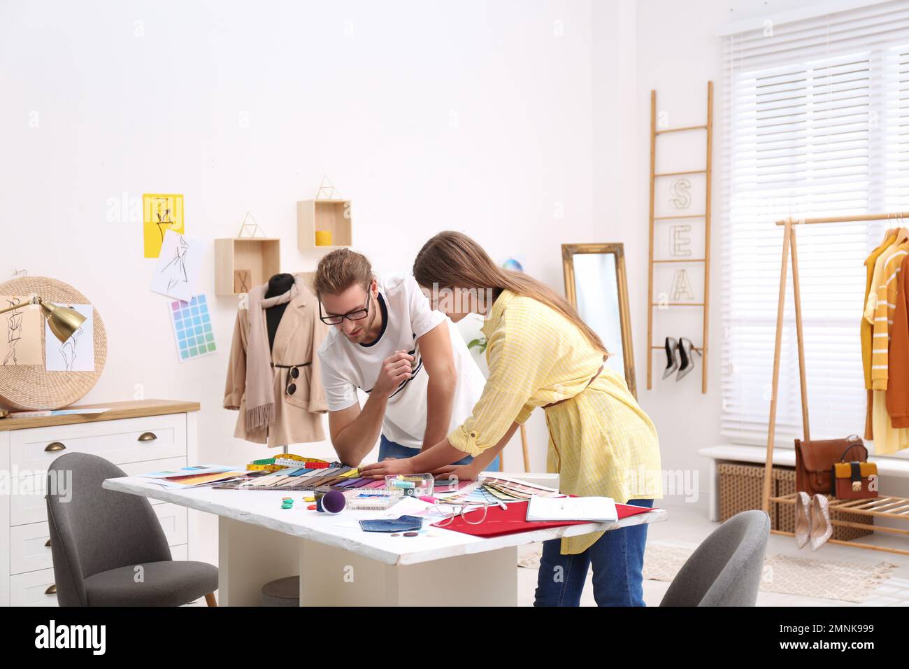 Fashion designers creating new clothes in studio Stock Photo - Alamy