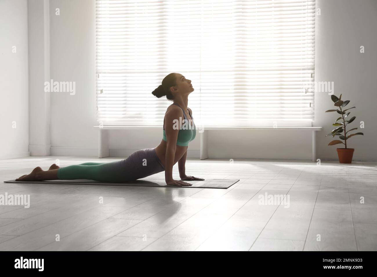 Woman practicing cobra asana in yoga studio. Bhujangasana pose Stock ...