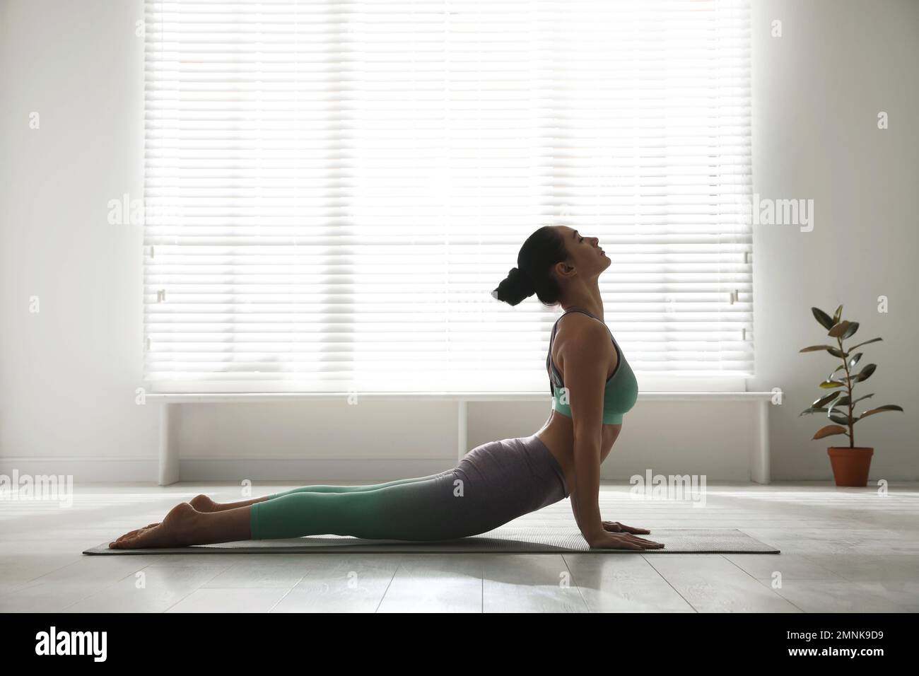 Woman practicing cobra asana in yoga studio. Bhujangasana pose Stock ...