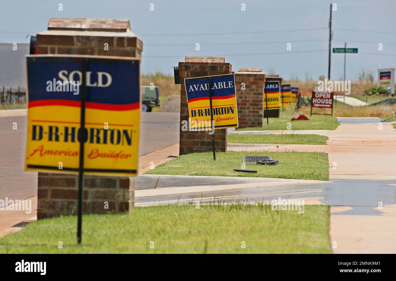 In this July 25, 2016, photo, real estate signs in a new home community ...