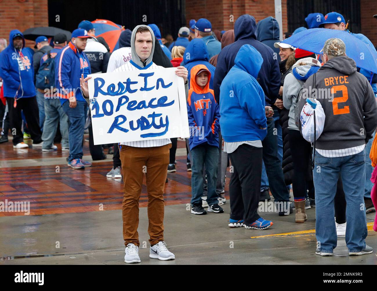 Chris Maloney, of Westbury, N.Y., holds a sign memorializing New York ...